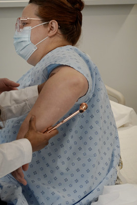 "Neurology_student testing triceps reflex using lifting arm technique_5" by